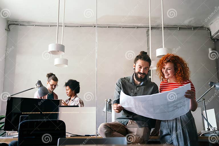 Engineers Helping Design Work on Blueprints, Collaborate on Structural ...