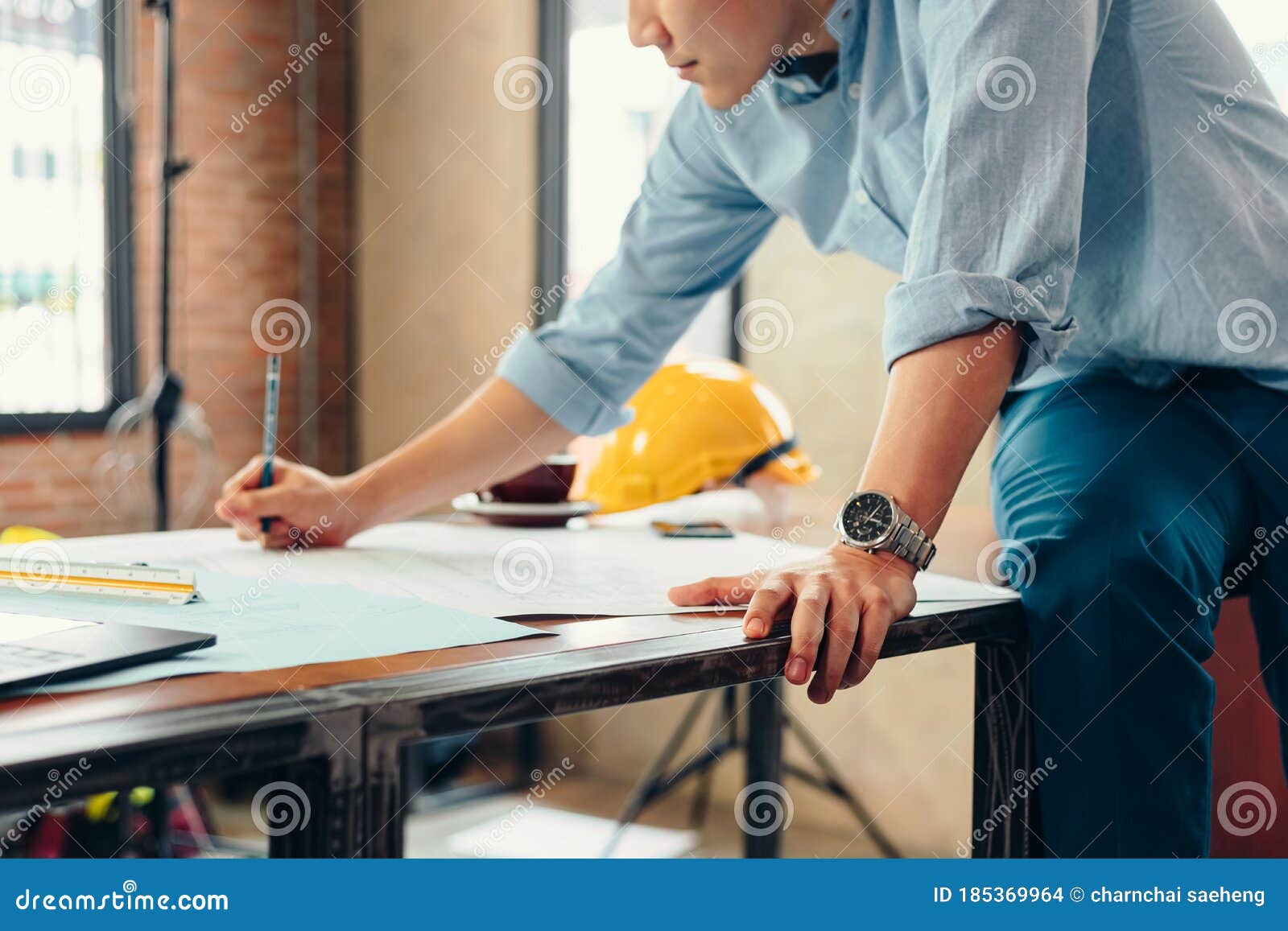 Engineers Holding a Pen Pointing To a Building and Drawing Outlay ...