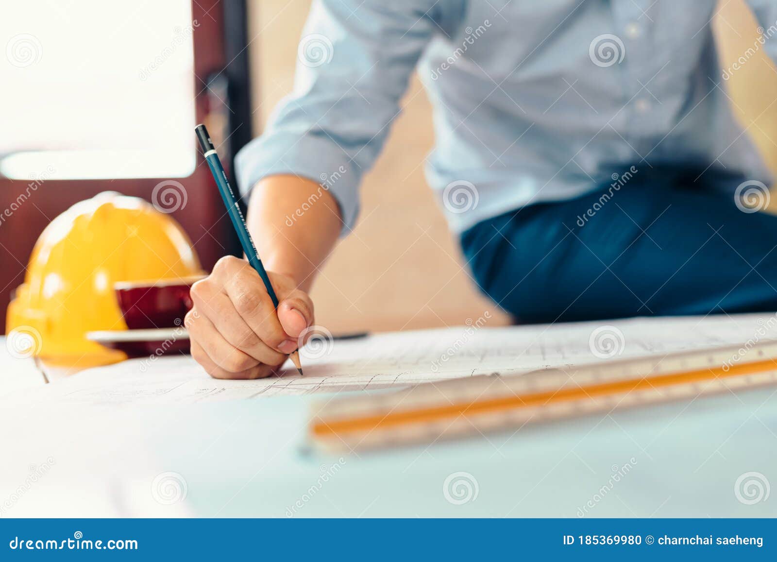 Engineers Holding a Pen Pointing To a Building and Drawing Outlay ...