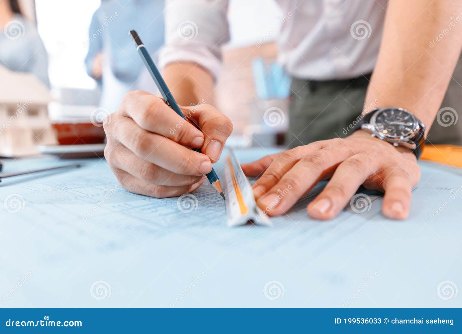 Engineers Holding a Pen Pointing To a Building and Drawing Outlay ...