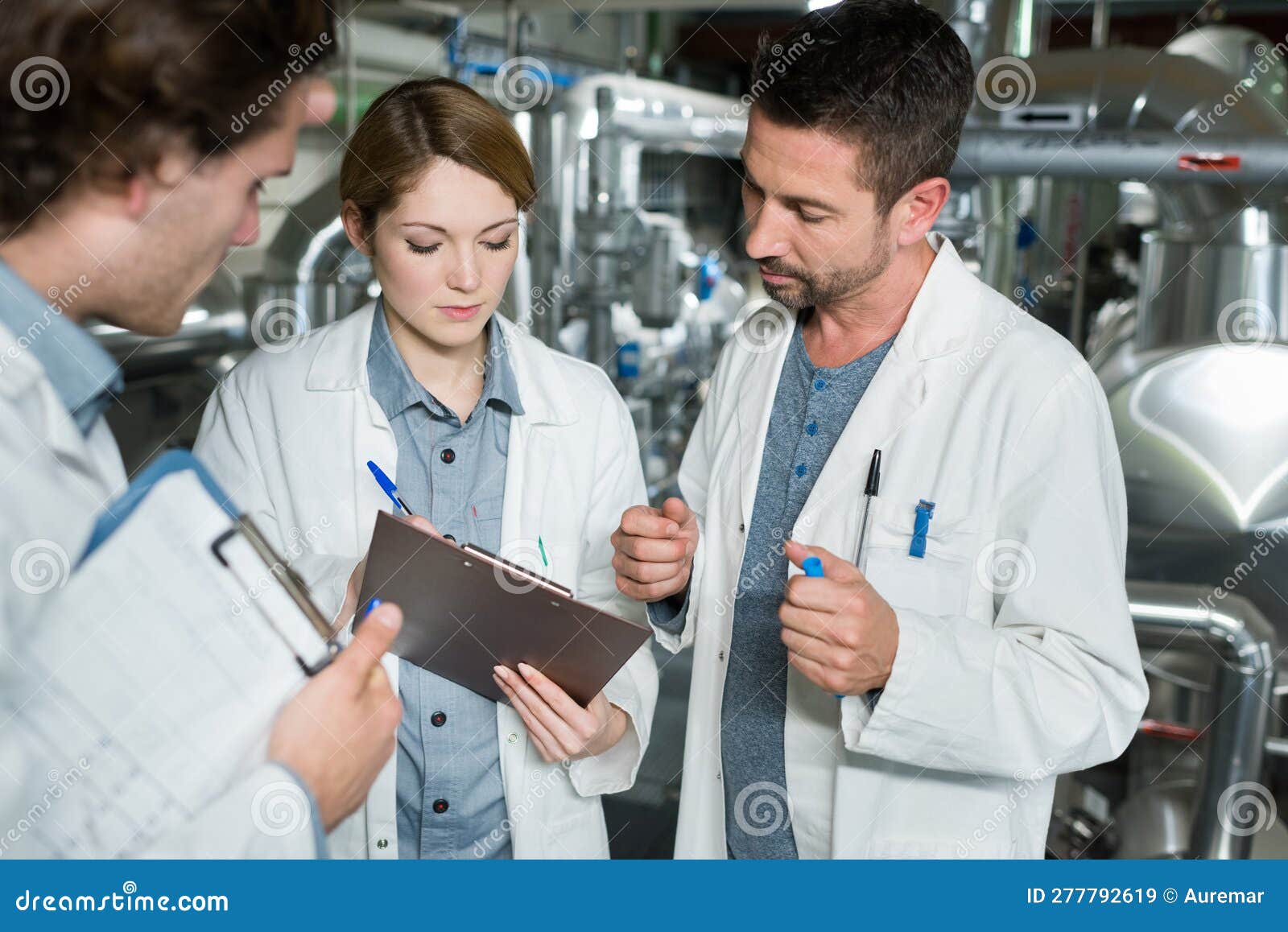 Engineers in Lab Coats Working in Factory Stock Image - Image of ...
