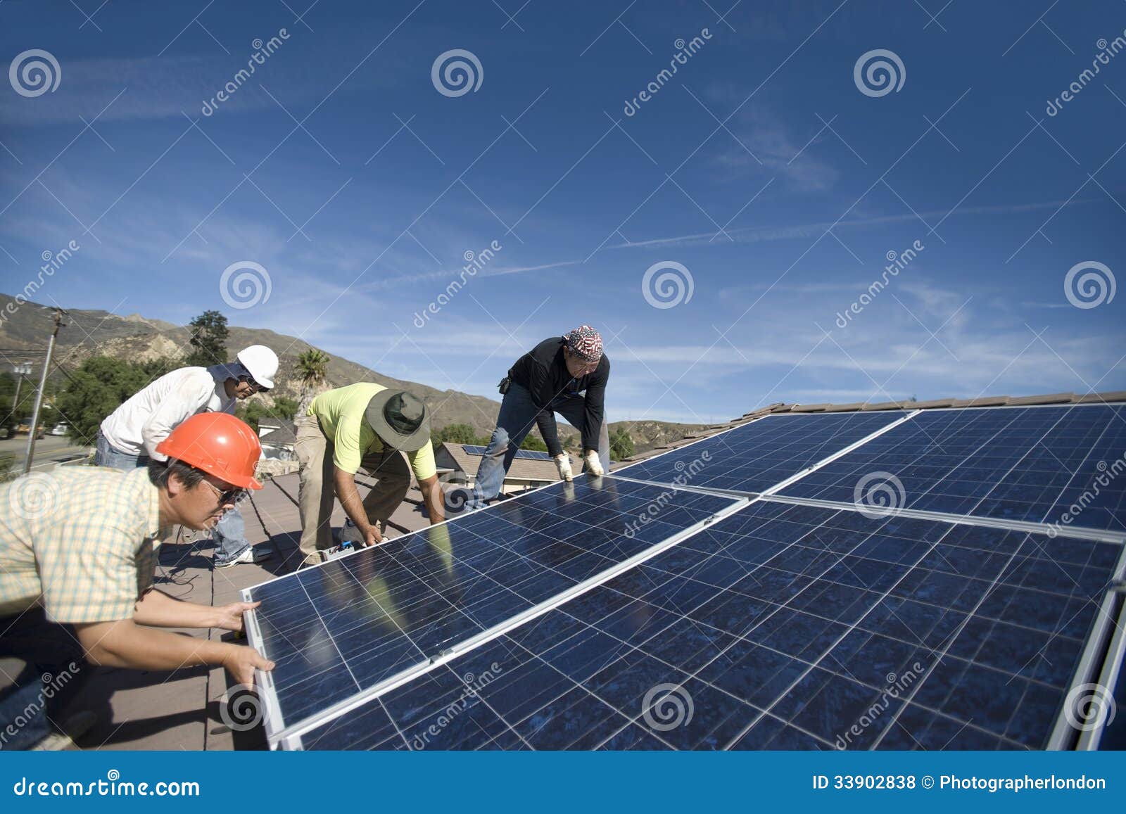 Engineers Lifting Heavy Solar Panel Against Blue Sky Stock Photo ...