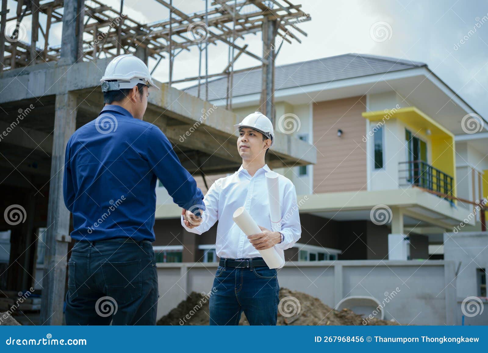 Engineers Man Handshake at Construction Site. Worker and Contruction Manager Shaking Hands while ...
