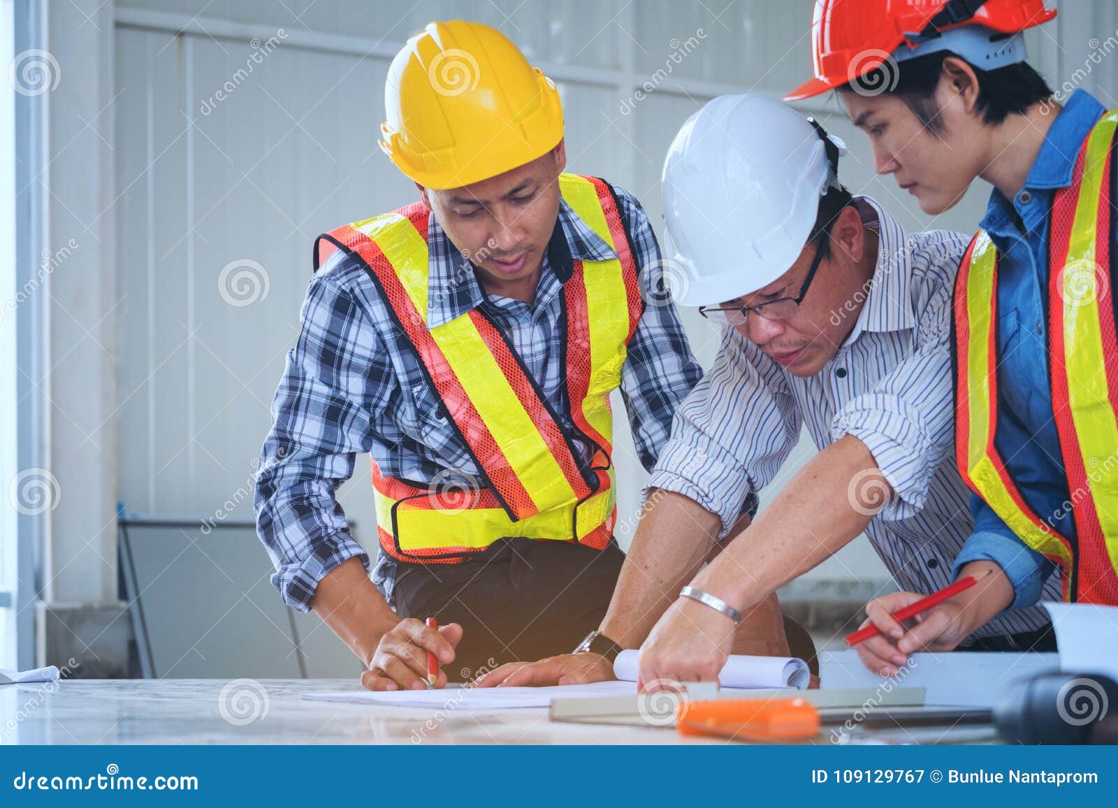 Engineers are Meeting, Working and Looking Blueprint in the Office To ...