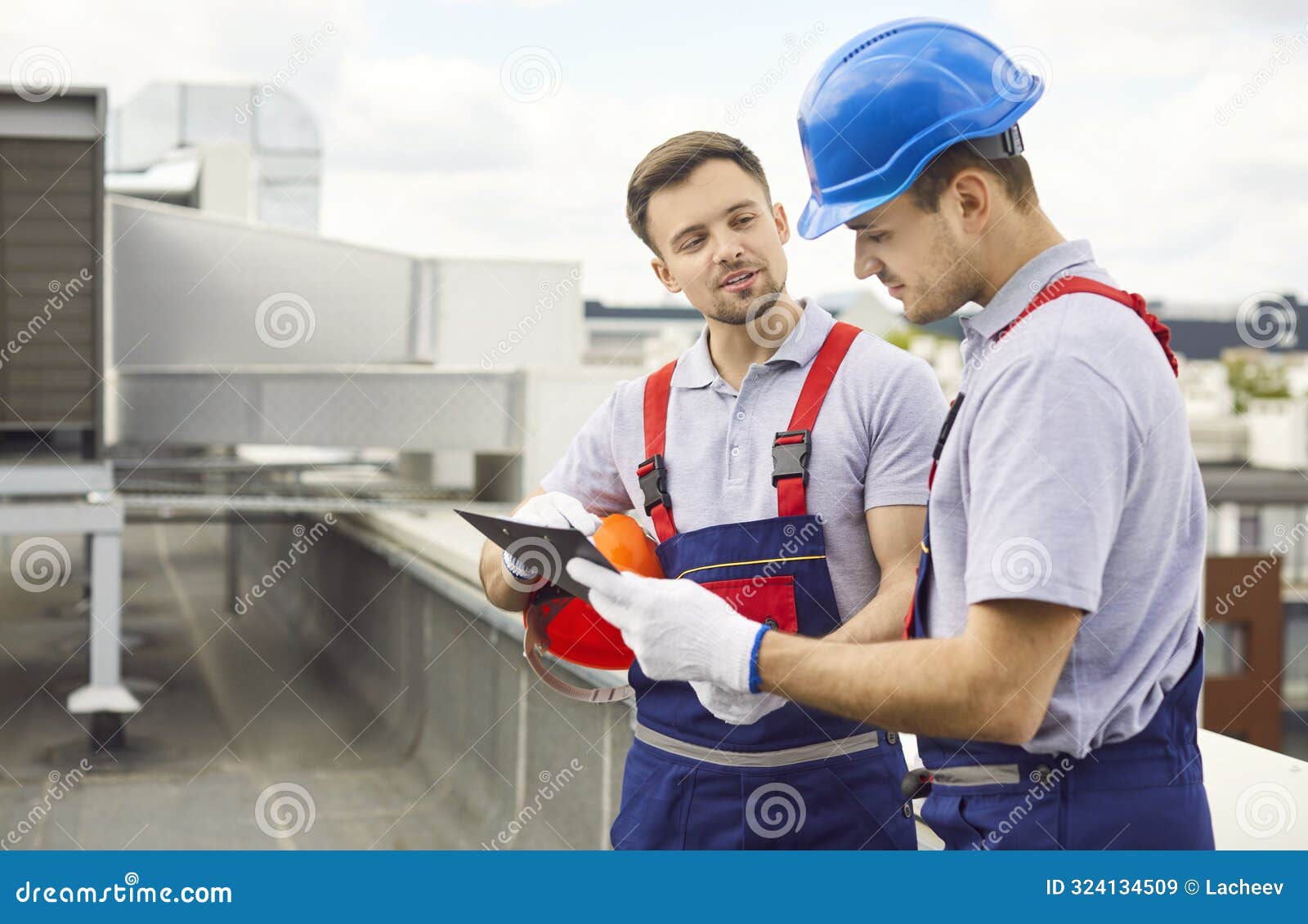 Engineers Planning Construction Site with Blueprints on Roof Stock ...