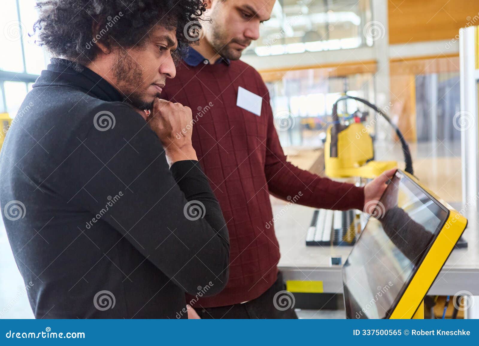 Engineers Programming Robotic Arm for Industry Automation in a Modern ...