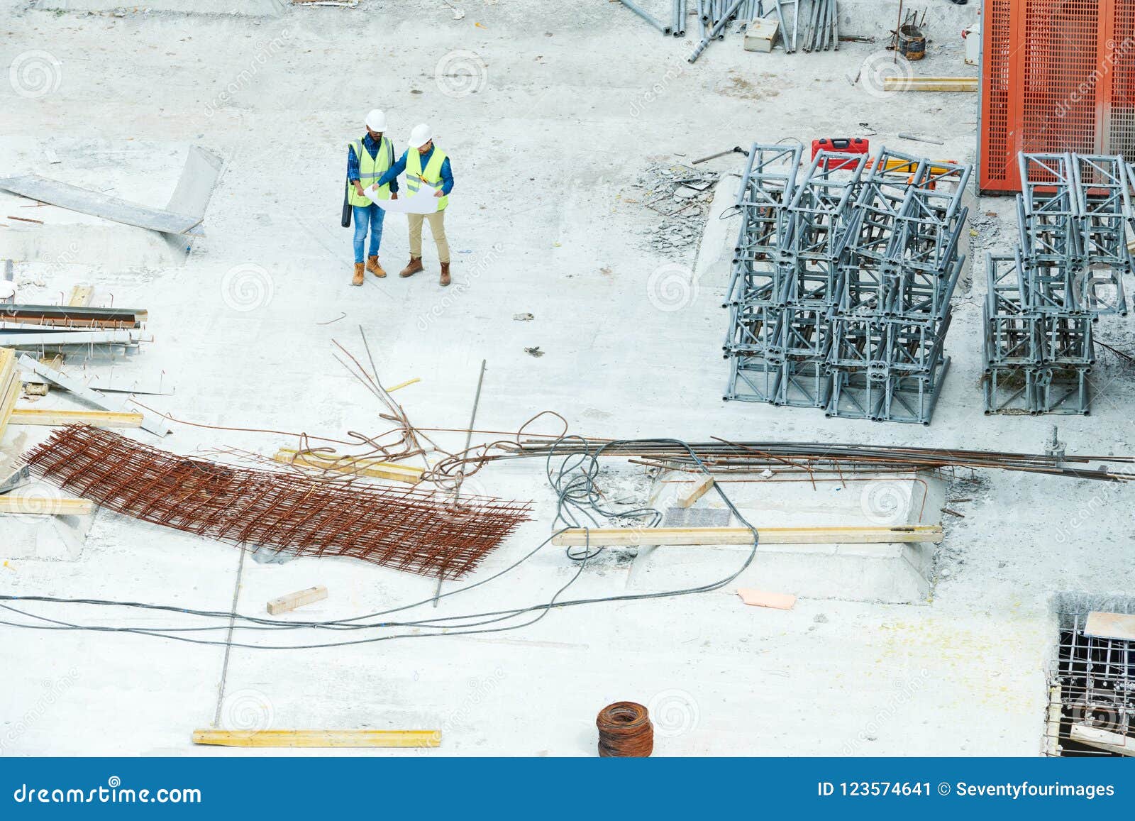 Engineers on Reading Blueprint on Construction Site Stock Image - Image ...