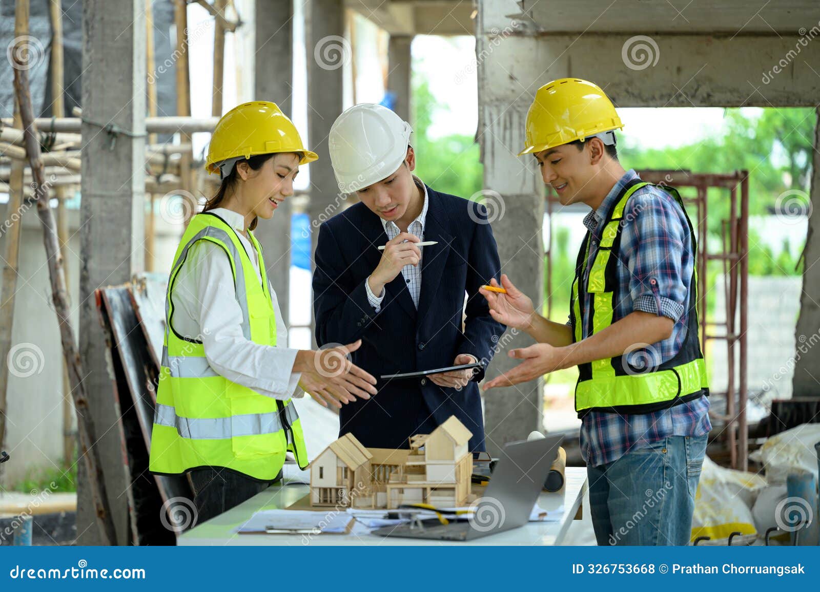 Engineers in Safety Helmet Collaborating and Sharing Ideas, with ...