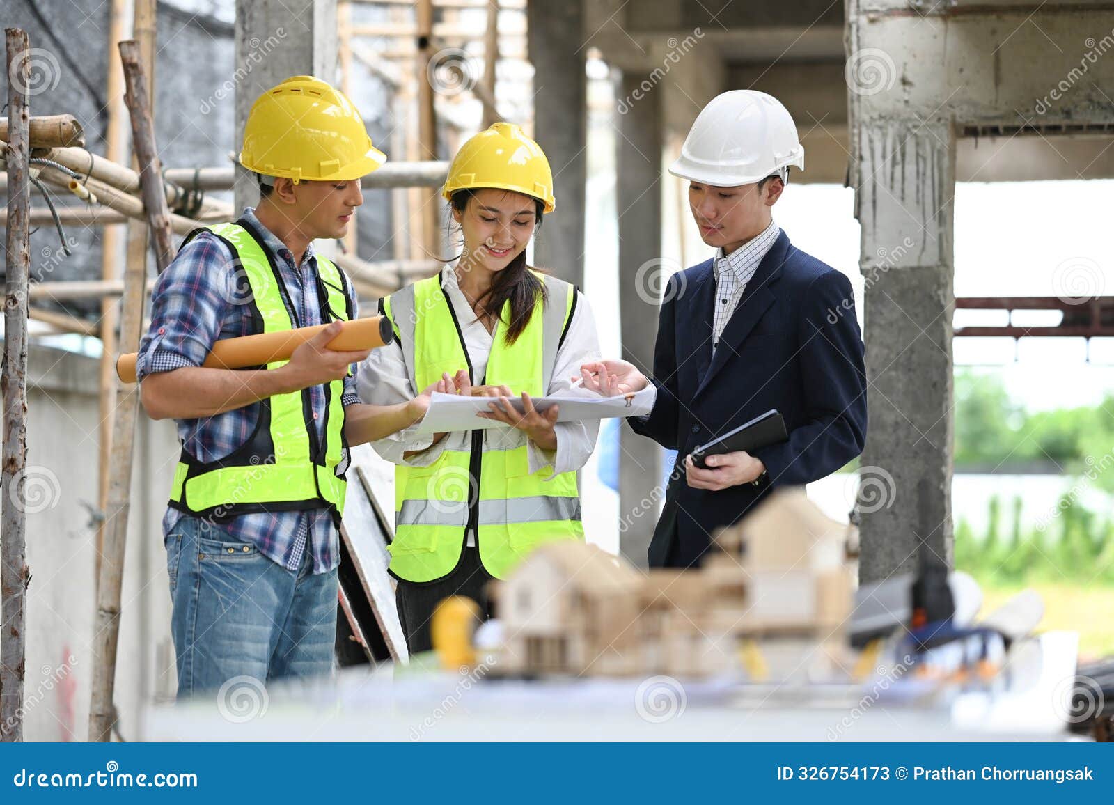 Engineers in Safety Helmet Collaborating and Sharing Ideas, with ...