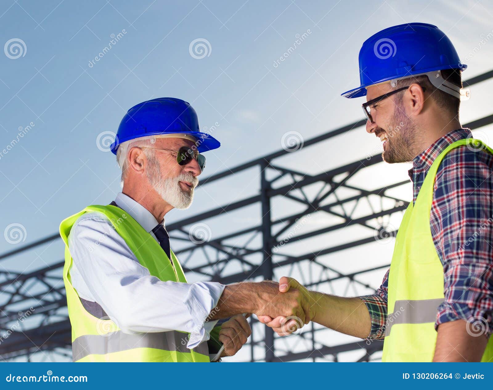Engineers Shaking Hands on Construction Site Stock Photo - Image of ...