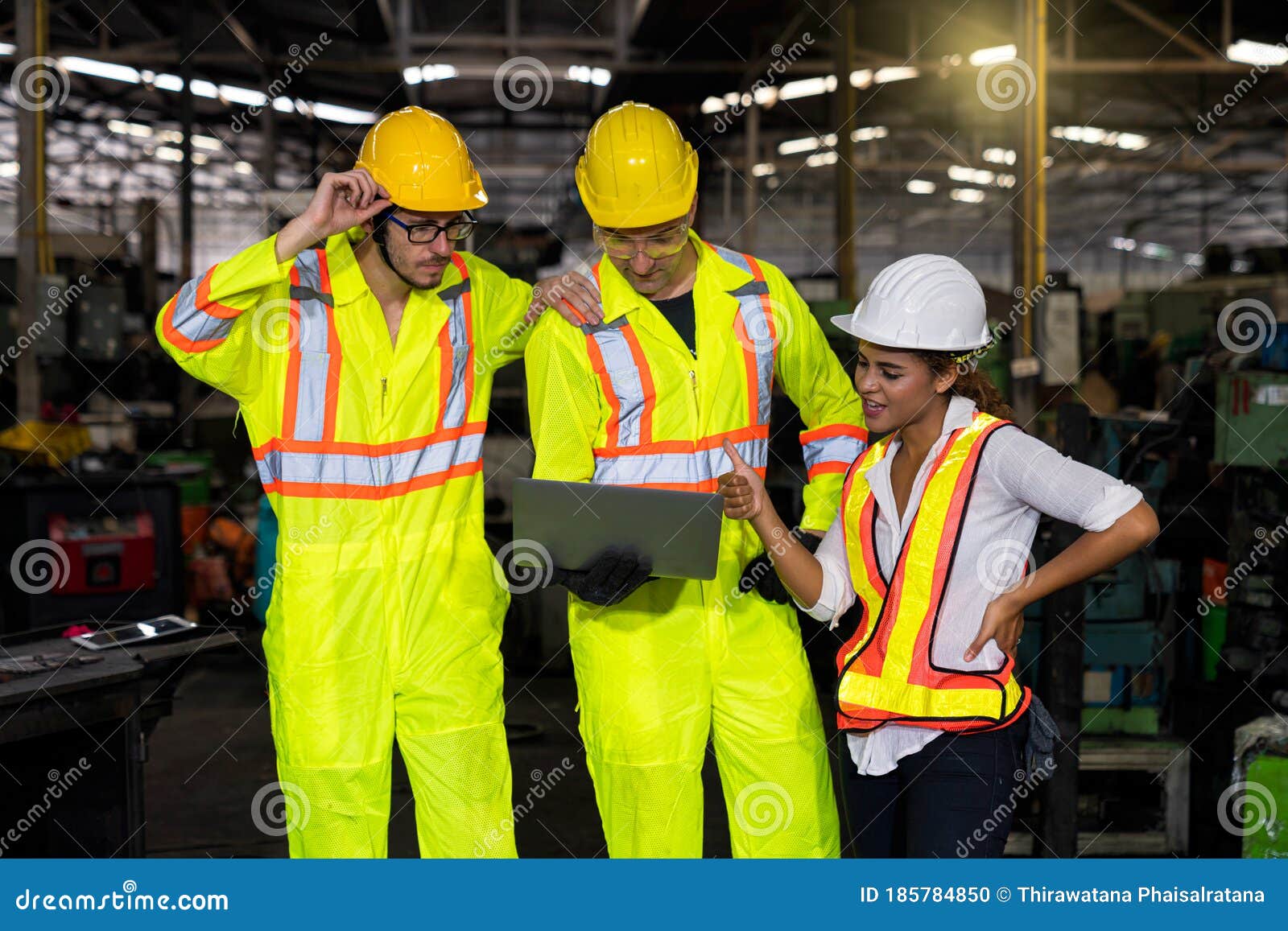Engineers and Skilled Technicians are Holding Laptops and Working in ...