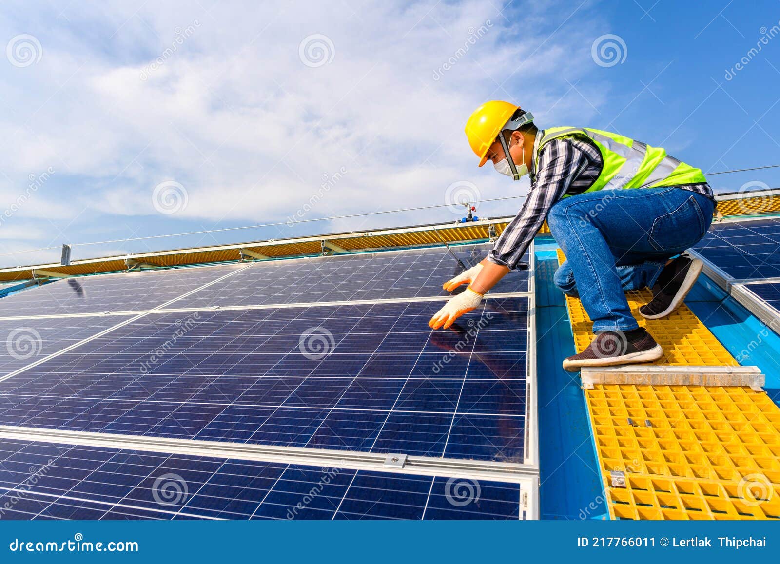 Engineers Use a Laptop Computer To Examine the Solar Panels at a Power ...