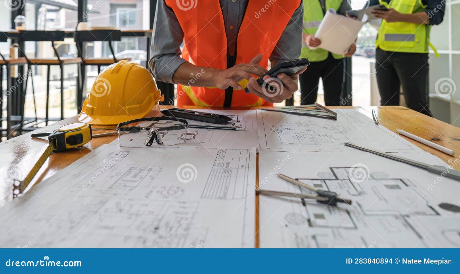 Engineers Working on Blueprints and Construction Plans. Building ...