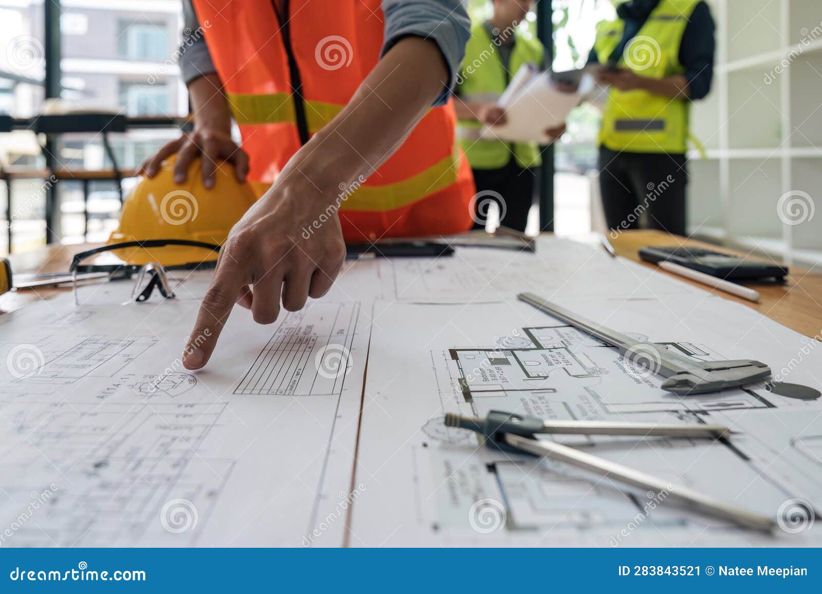 Engineers Working on Blueprints and Construction Plans. Building ...