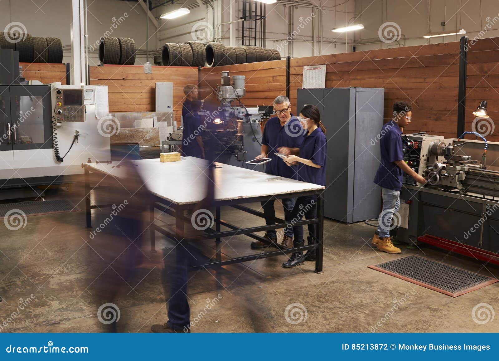 Engineers Working on Machines in Busy Metal Workshop Stock Photo ...
