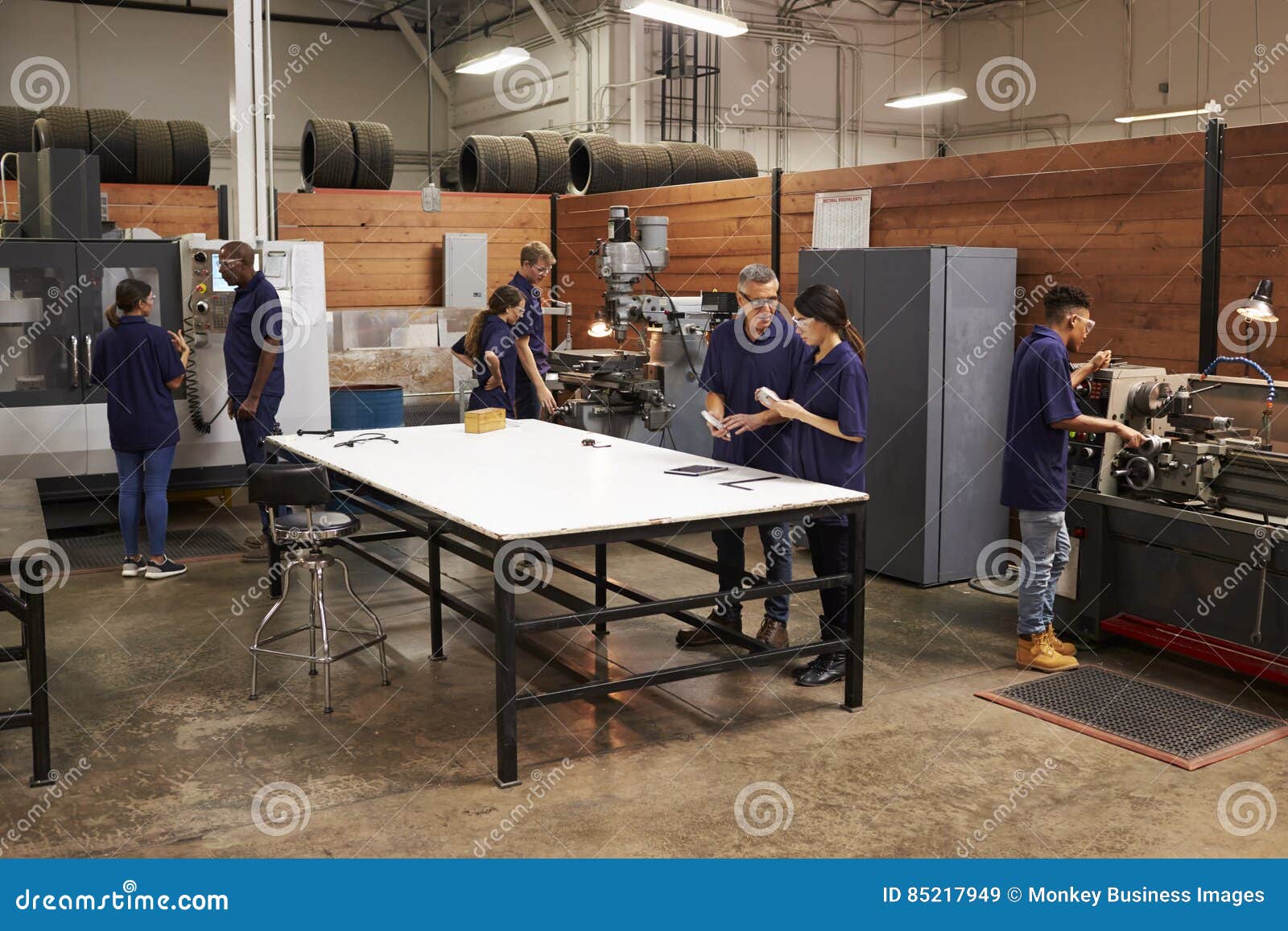 Engineers Working on Machines in Busy Metal Workshop Stock Image ...