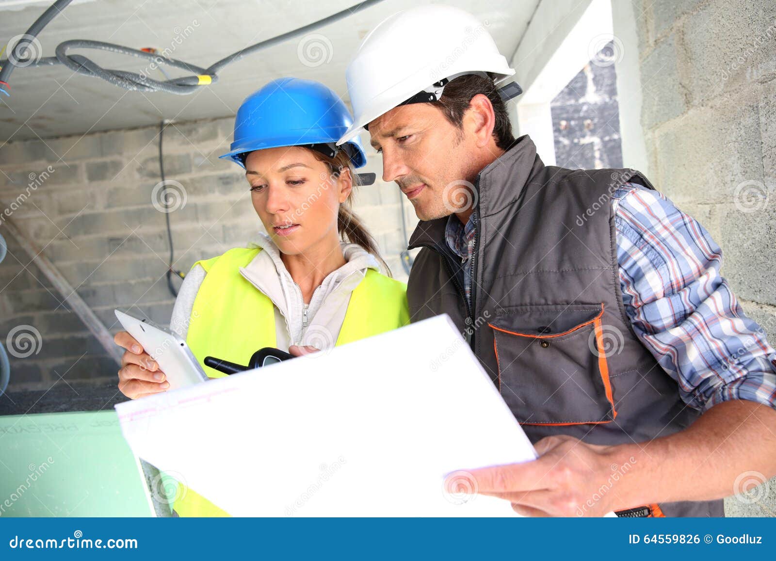 Engineers Working Together on Construction Site Stock Photo - Image of ...