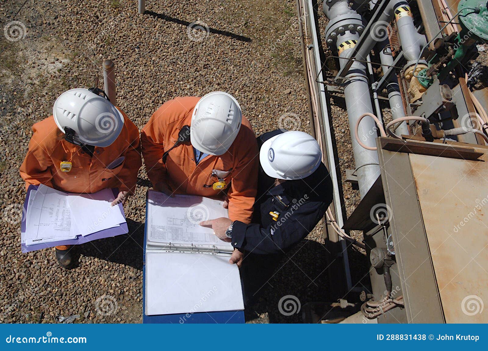 Engineers on Worksite at Refinery Discuss the Plans-above Shot. Stock ...