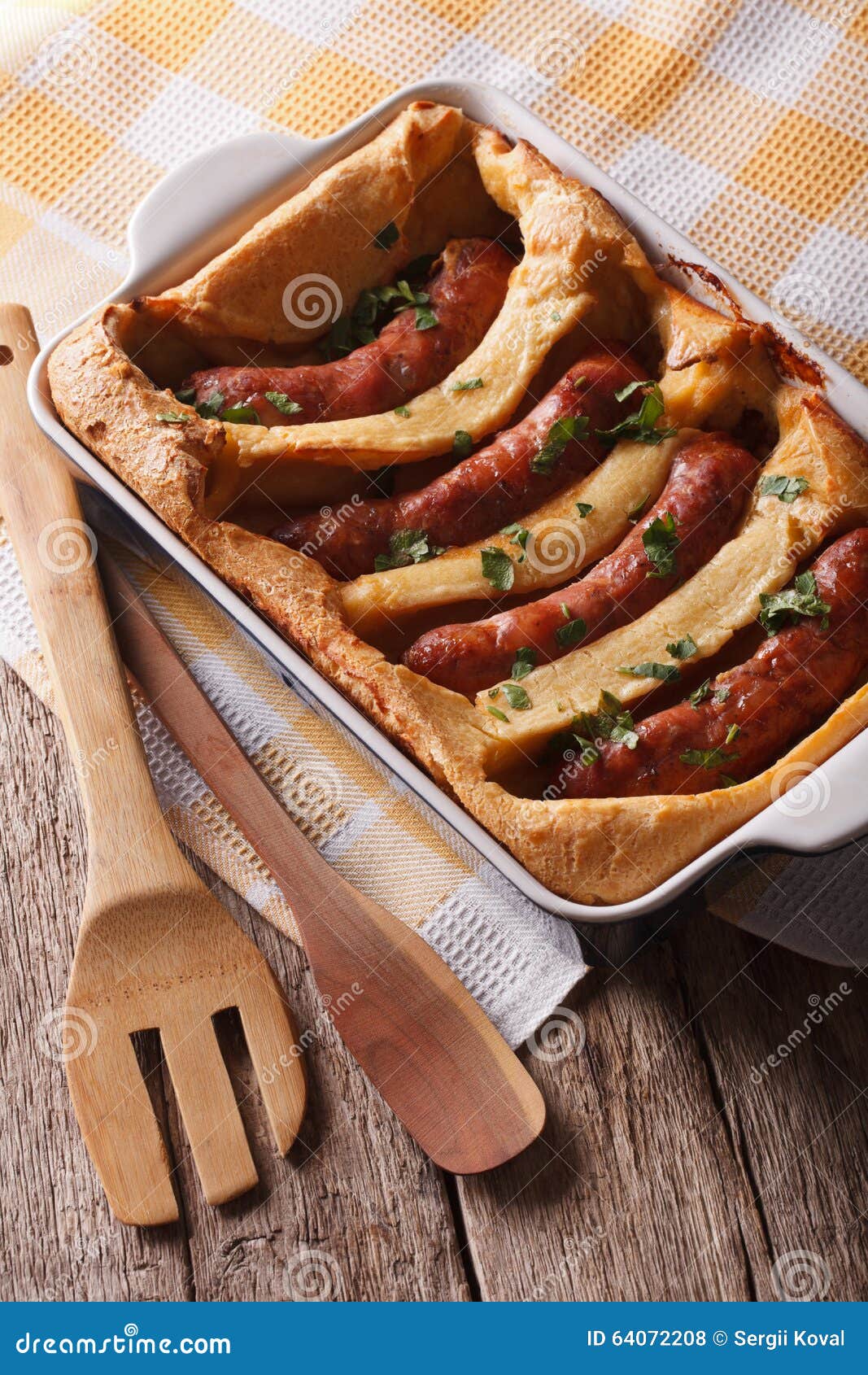 English Food: Toad in the Hole into a Baking Dish Close Up. Vert Stock ...