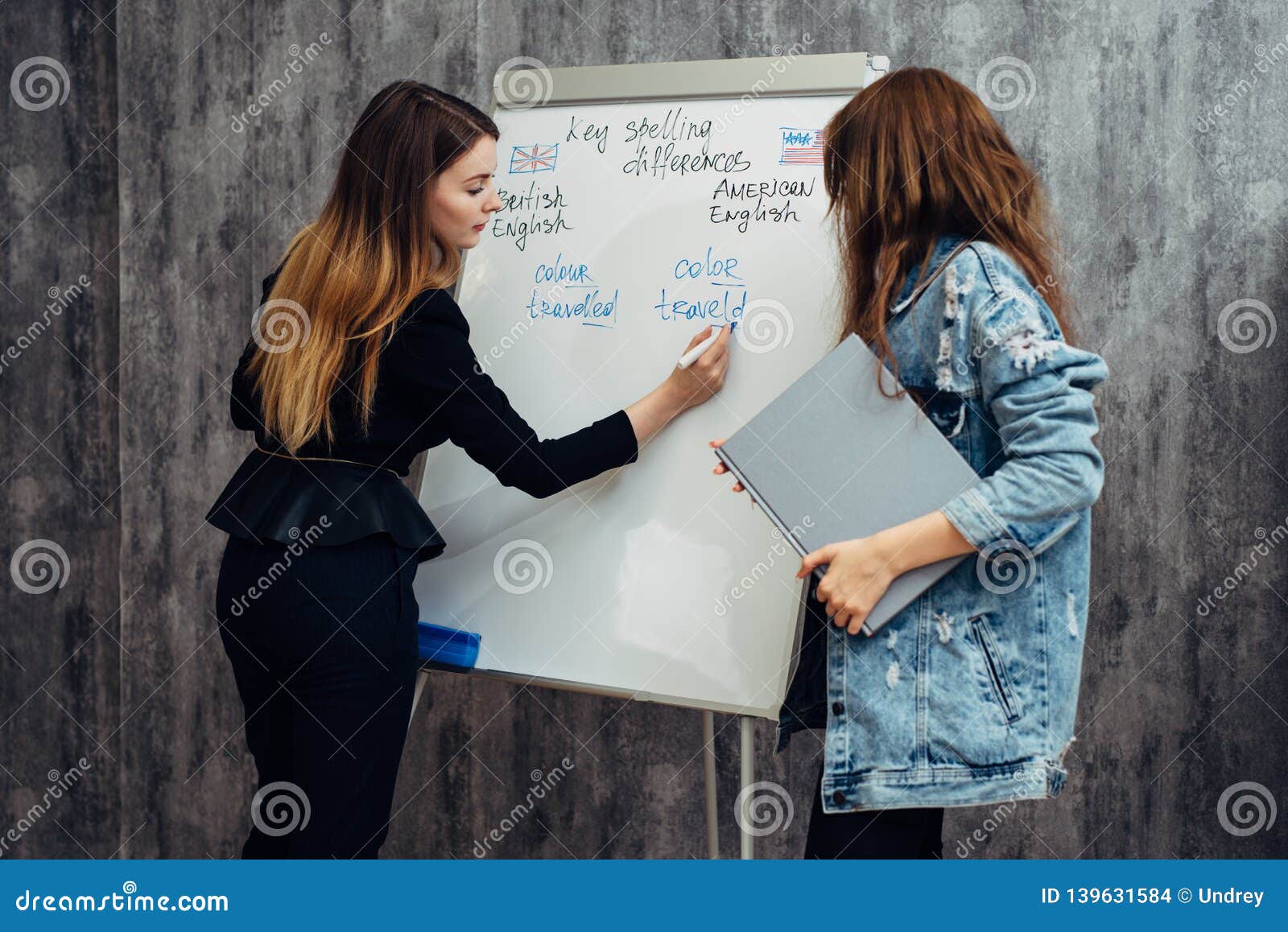 English Language School. Two Female Students Talking in Classroom ...