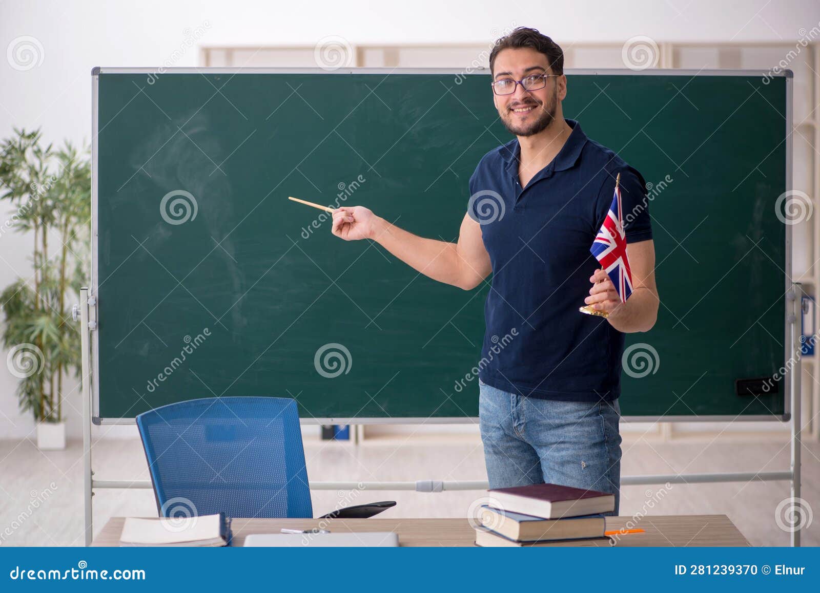 Male English Language Teacher in Front of Green Board Stock Photo ...