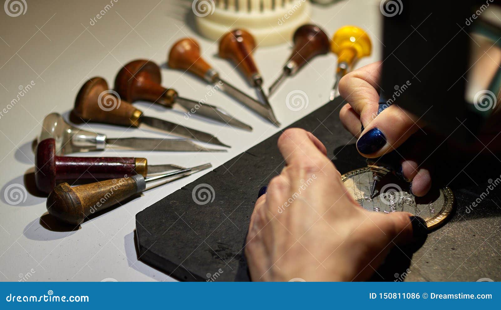 Woman engraver at work. stock photo. Image of engraving - 150811086