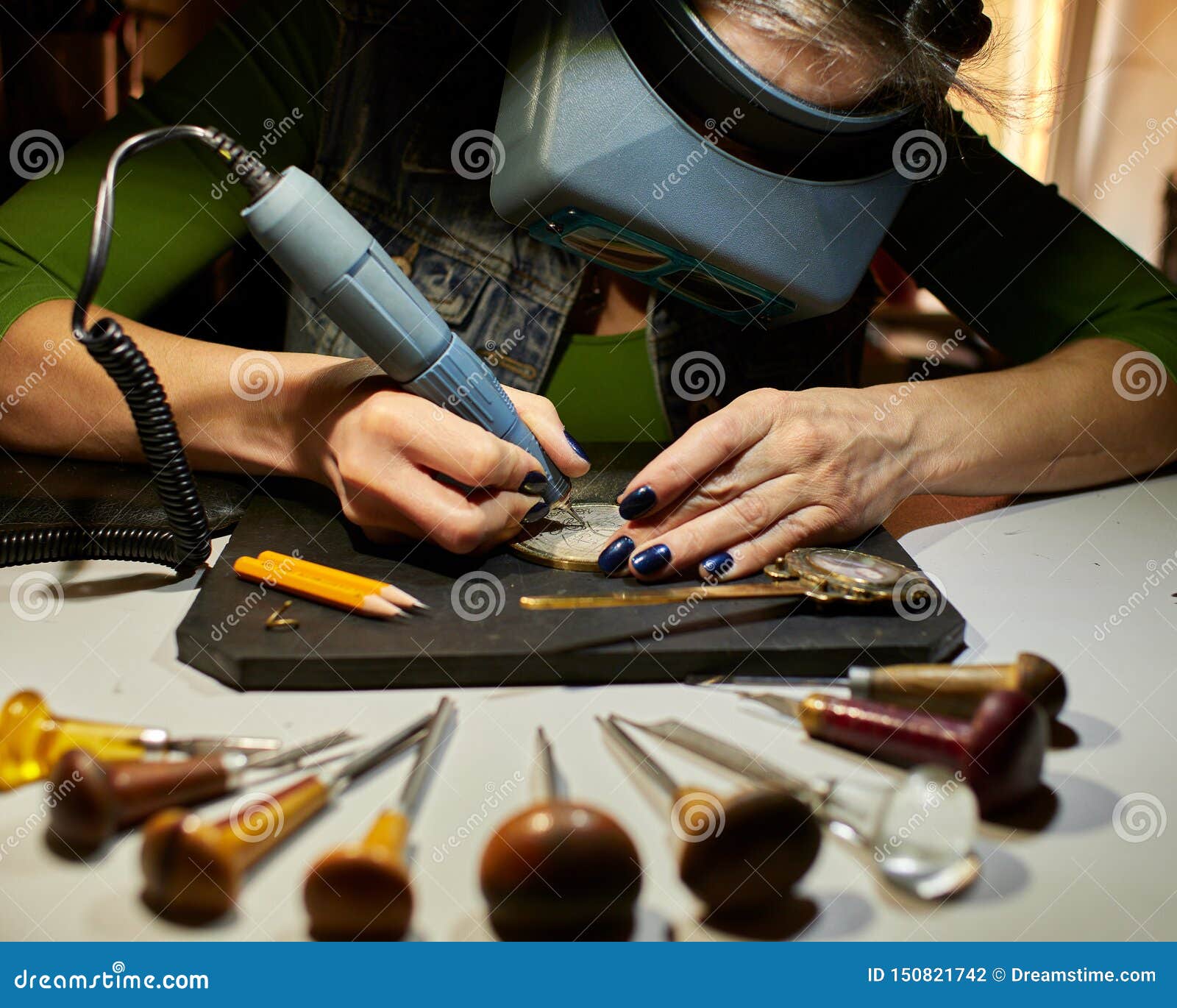 Woman engraver at work. stock photo. Image of engraver - 150821742