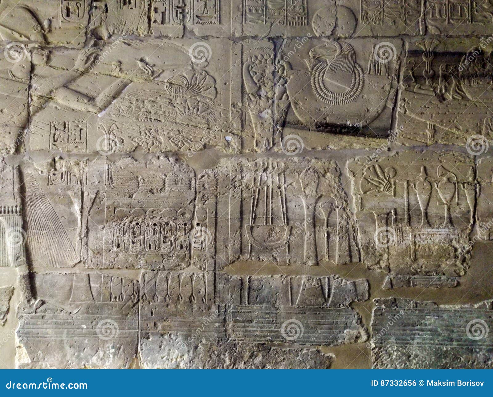 Engravings on the Wall of the Ancient Temple of Egypt. Stock Photo ...