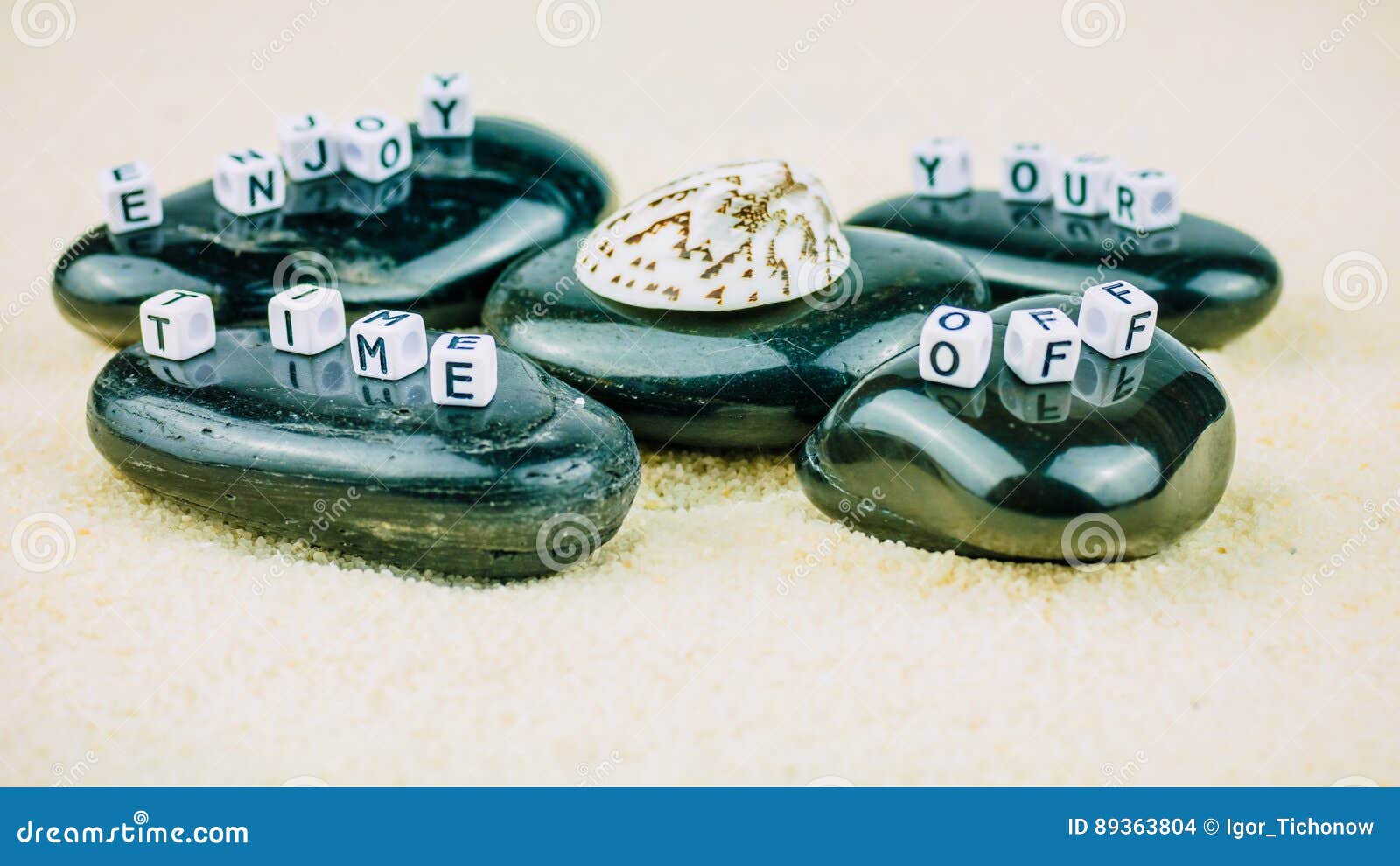 Enjoy Your Time Off Cube Letters on Black Stones on Sandy Background ...