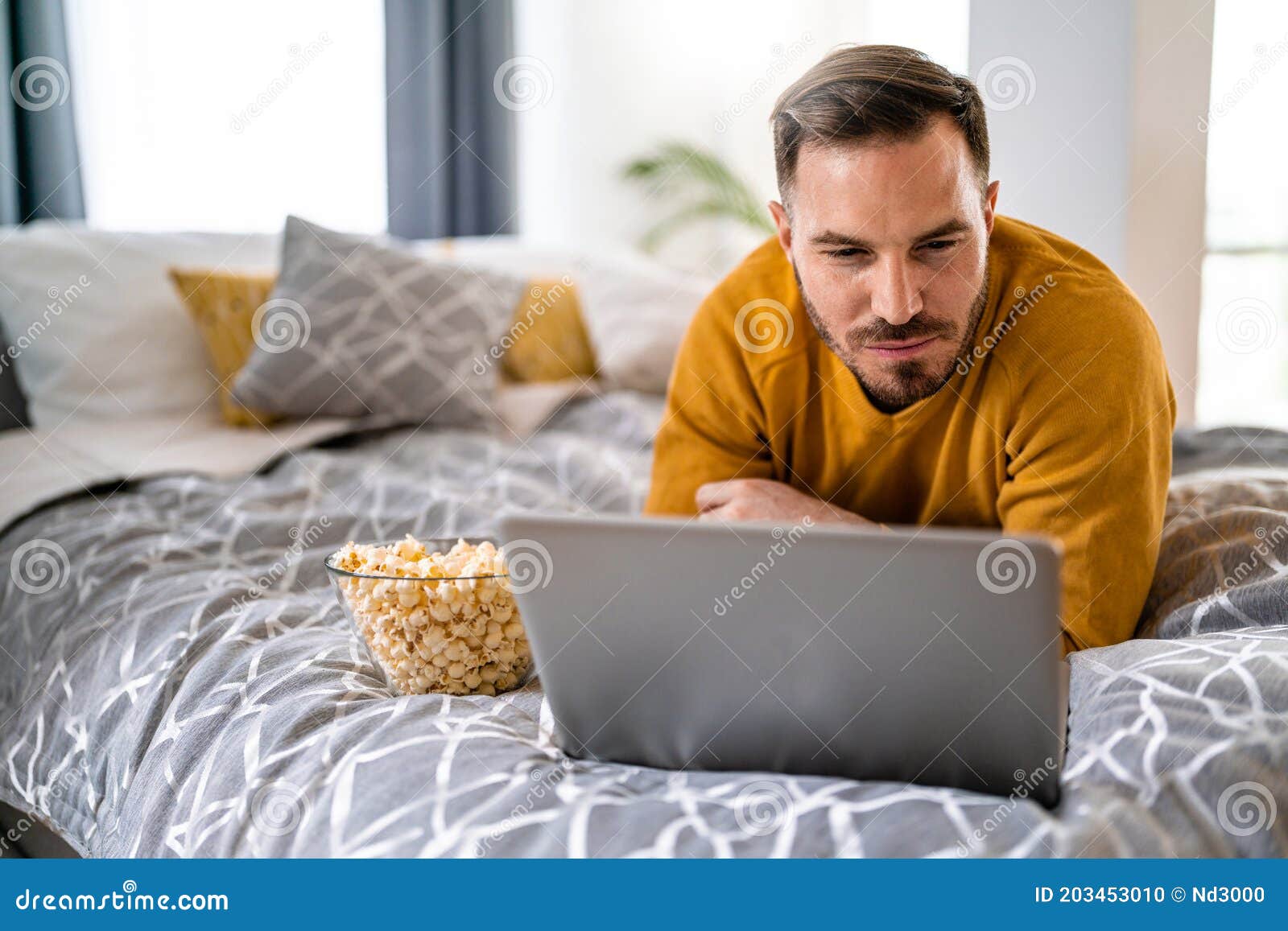 Enjoying His Leisure Time at Home. Handsome Young Man Using Computer ...
