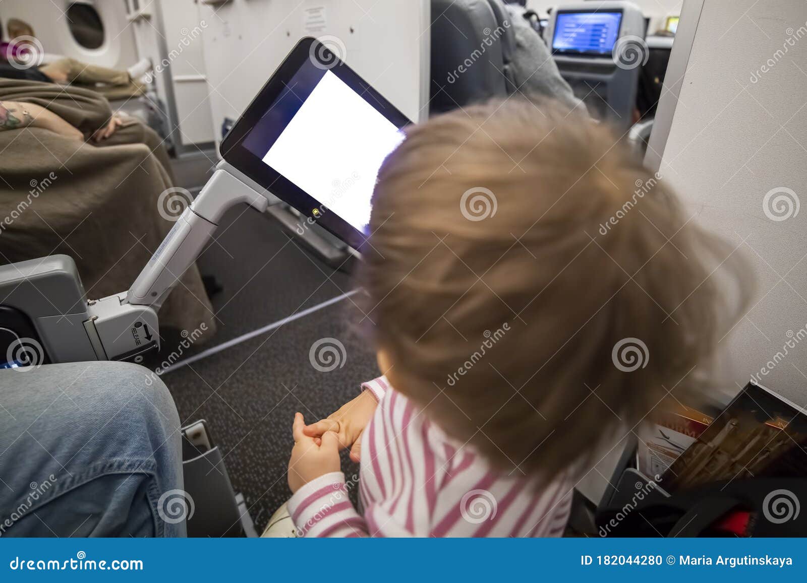 Entertainment On Board The Aircraft In Flight. Kid Shows Finger In ...