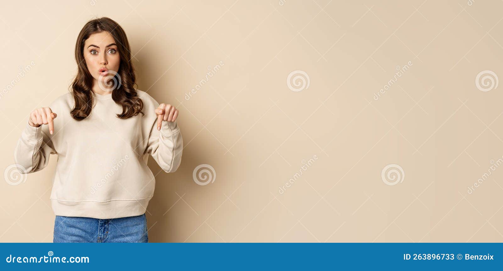 Enthusiastic Attractive Girl Pointing Fingers Down Showing