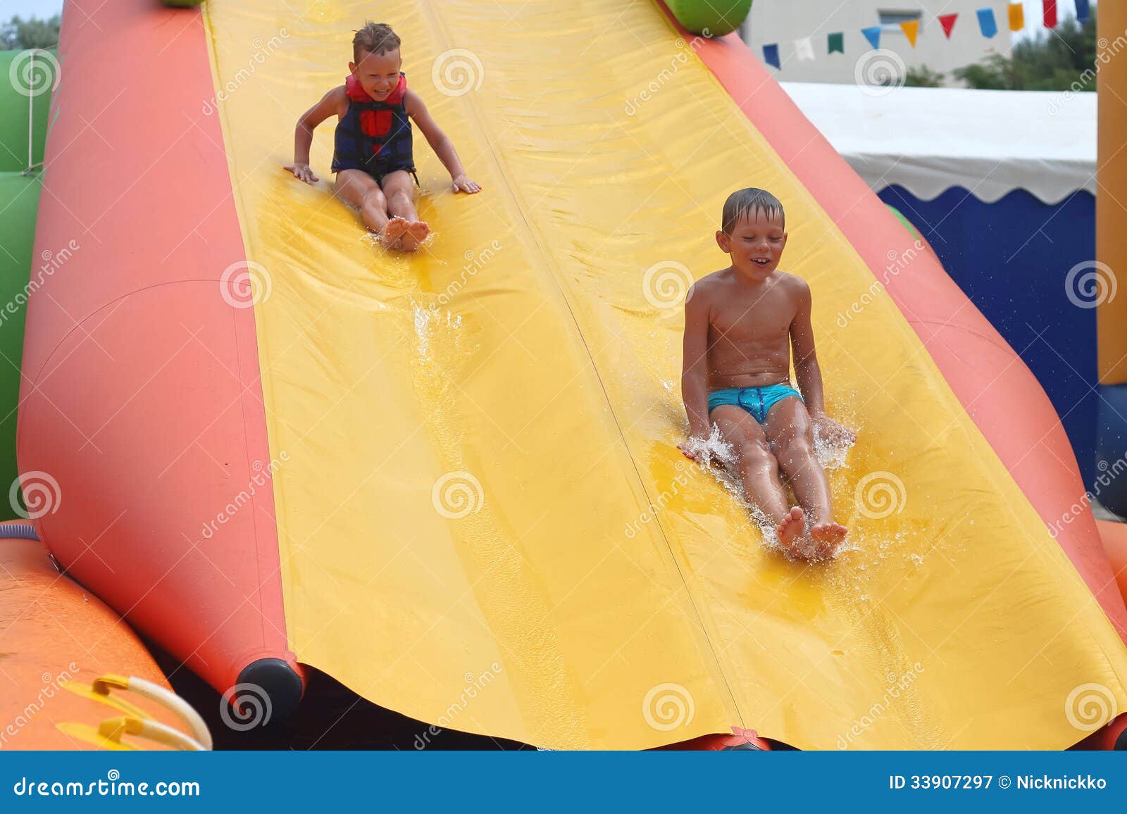 Enthusiastic kids on slide stock image. Image of ride - 33907297