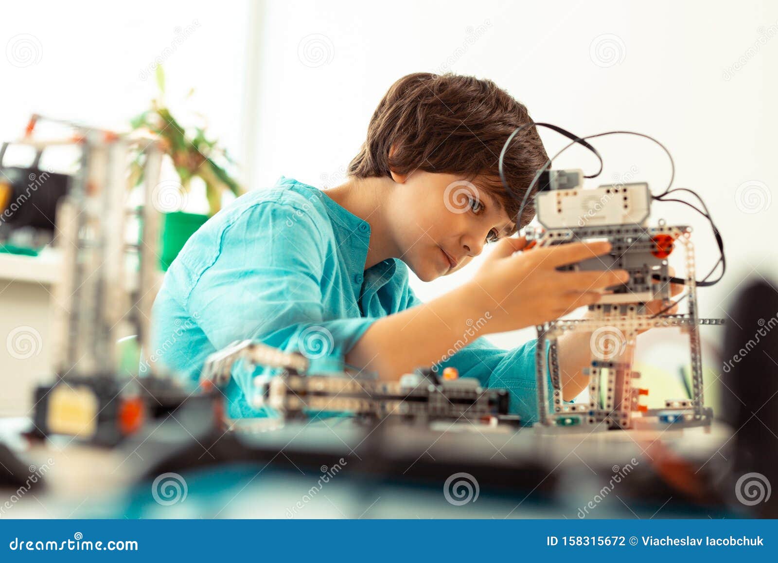 Enthusiastic Pupil Fixing the Robot at Science Lesson. Stock Photo ...