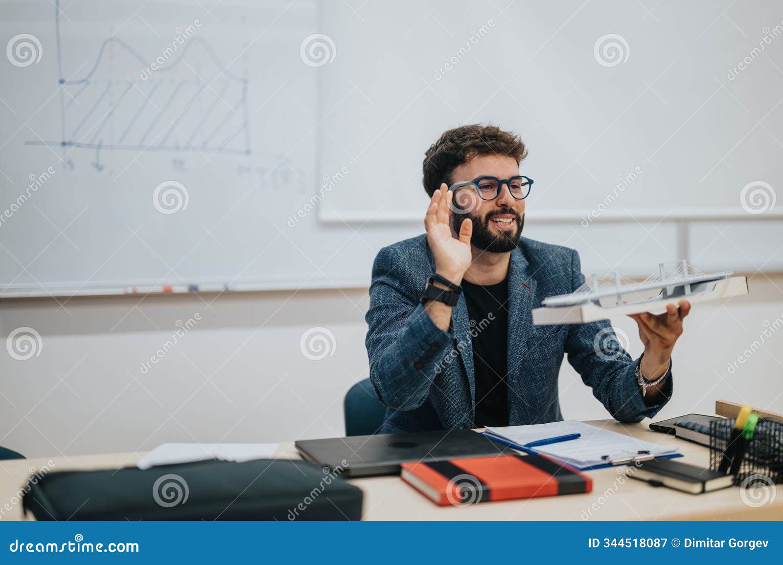 Enthusiastic Teacher Explaining Architectural Model To Students in ...