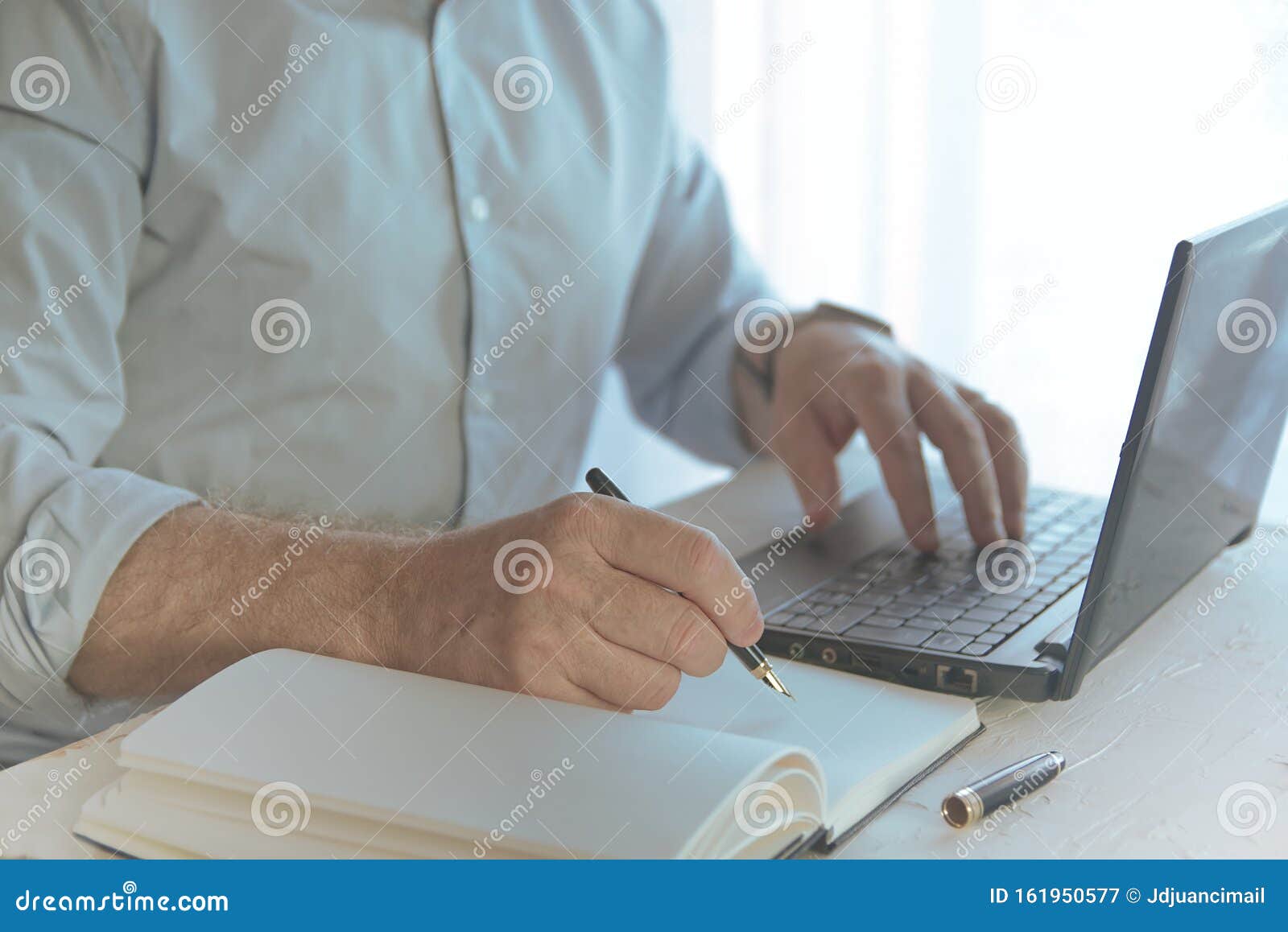 Entrepreneur Working at Home Office with a Computer, Notebook and Some ...