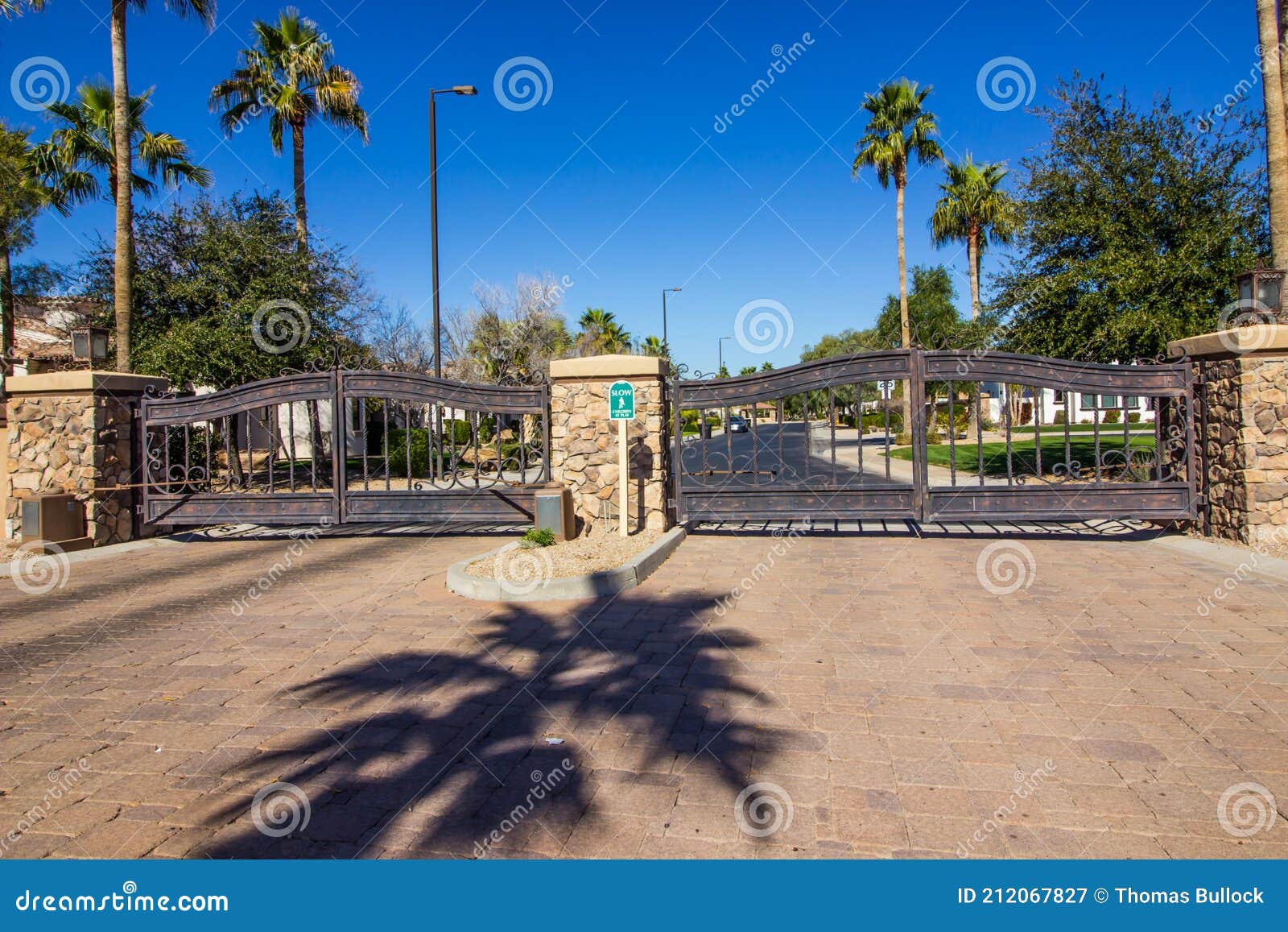 Entry and Exit Gates Framed by Palm Trees Stock Image - Image of metal ...