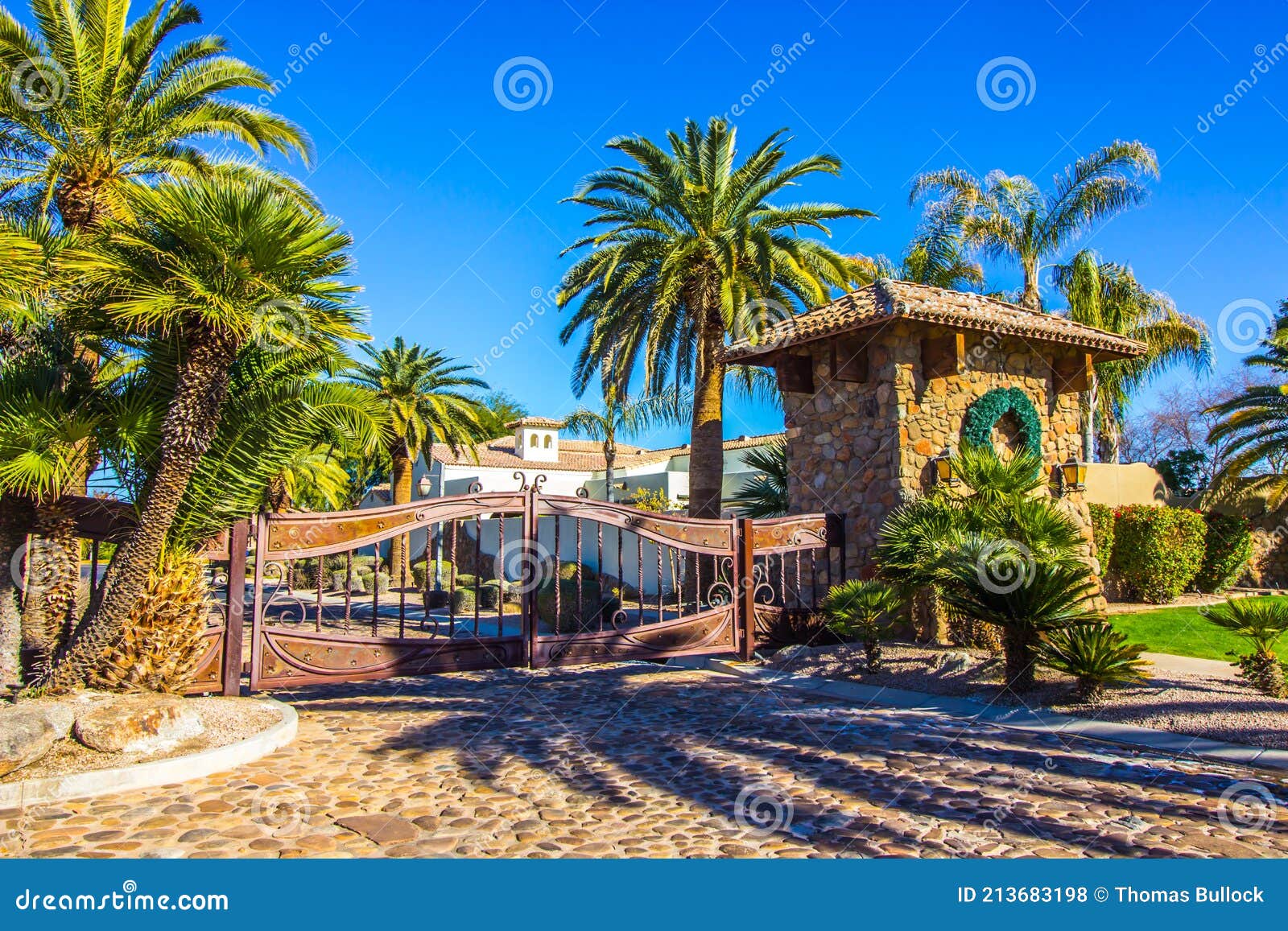 Entry Gate Surrounded by Palm Trees Stock Photo - Image of roof, hedges ...