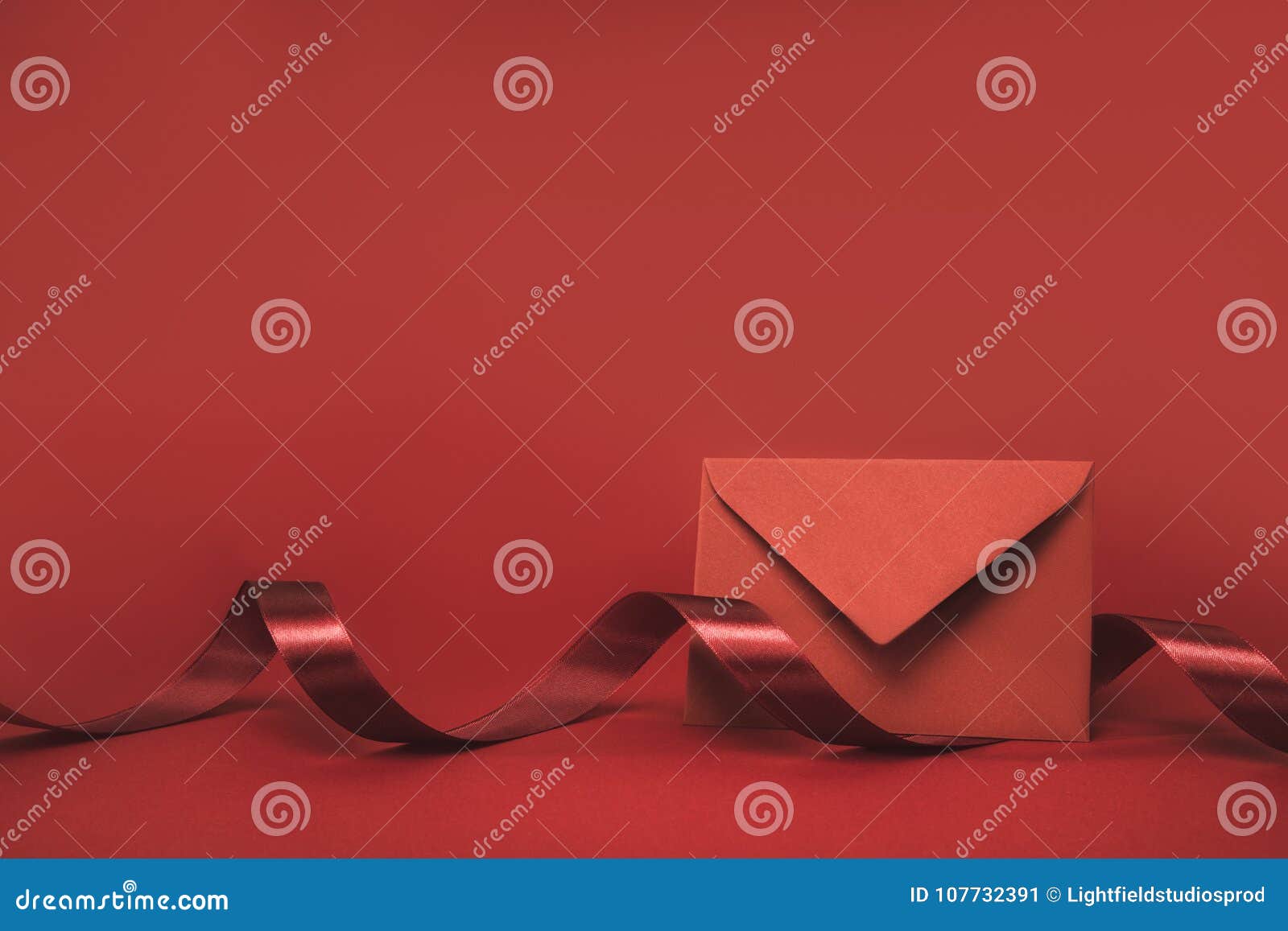 Envelope and ribbon on red stock image. Image of celebration - 107732391
