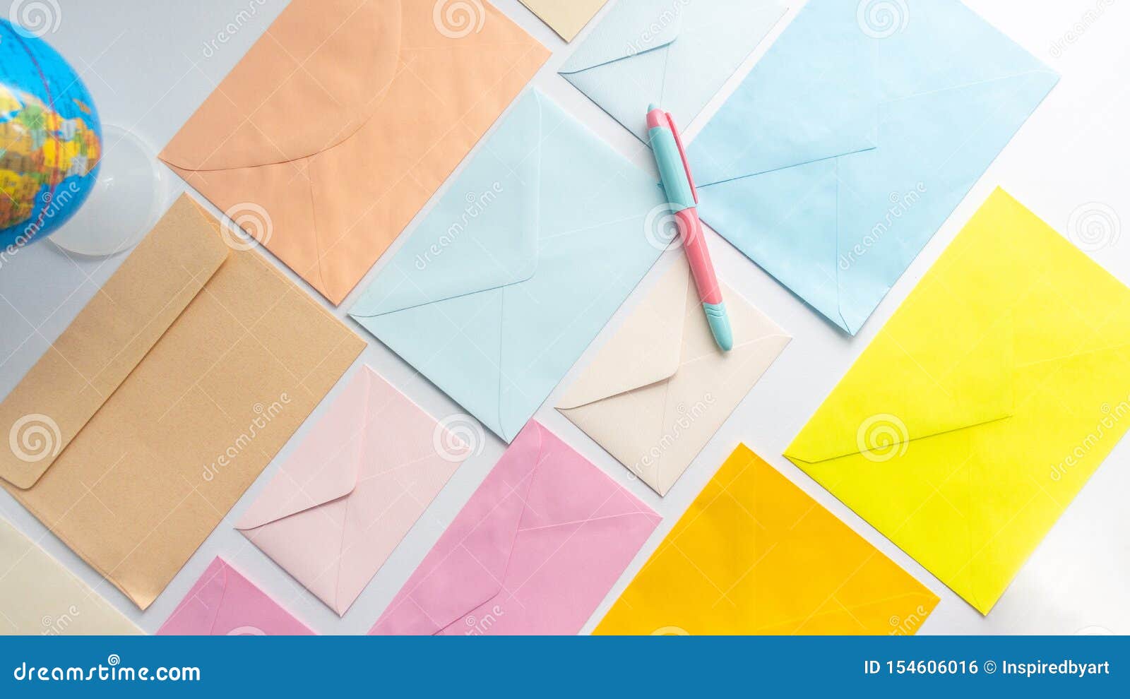 Envelopes in Pastel Colors Align in Oblique Style with a Globe on the ...