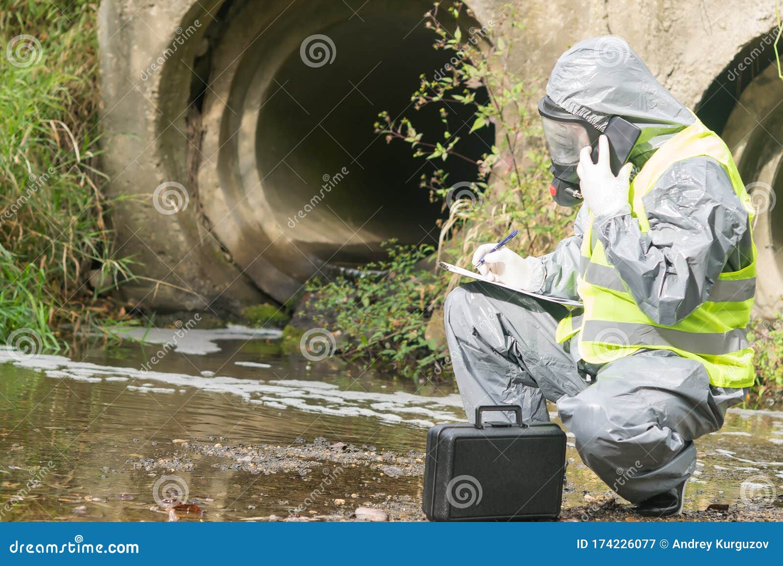 Environmental Specialist in a Protective Suit and Mask Talking on the ...