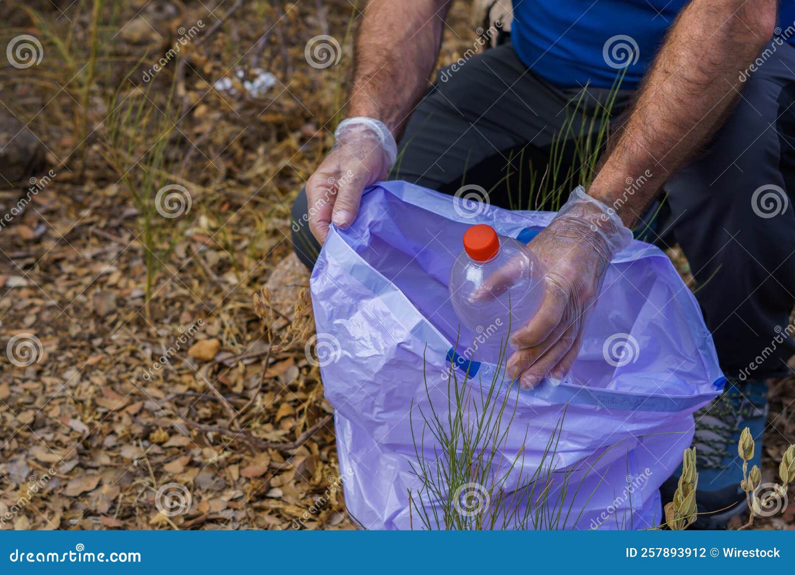 Environmentalist Man Picking Up Garbage from the Field Stock Photo ...