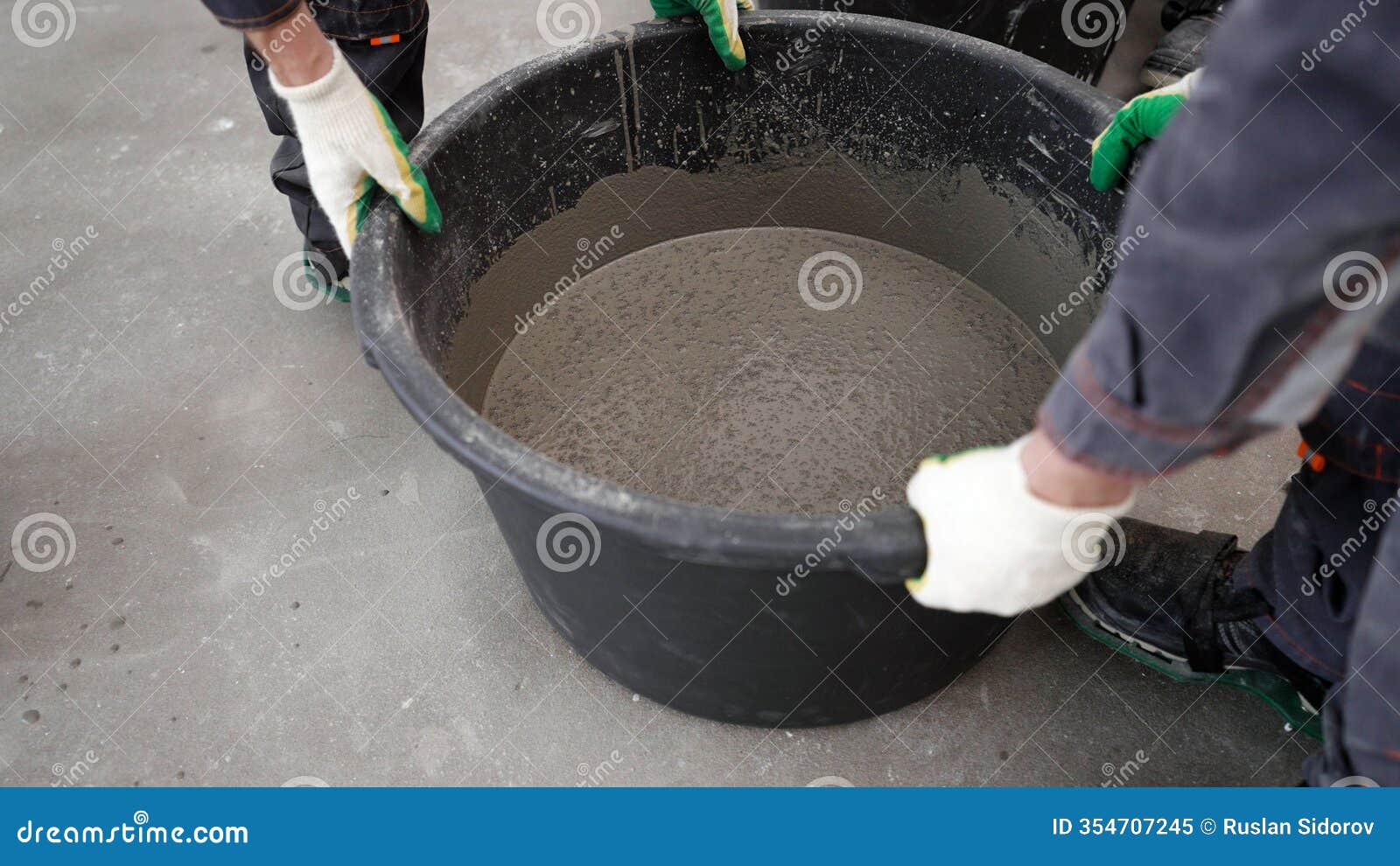 Epoxy Mixture is Poured on the Floor, by Two Workers. Workers Pouring a ...