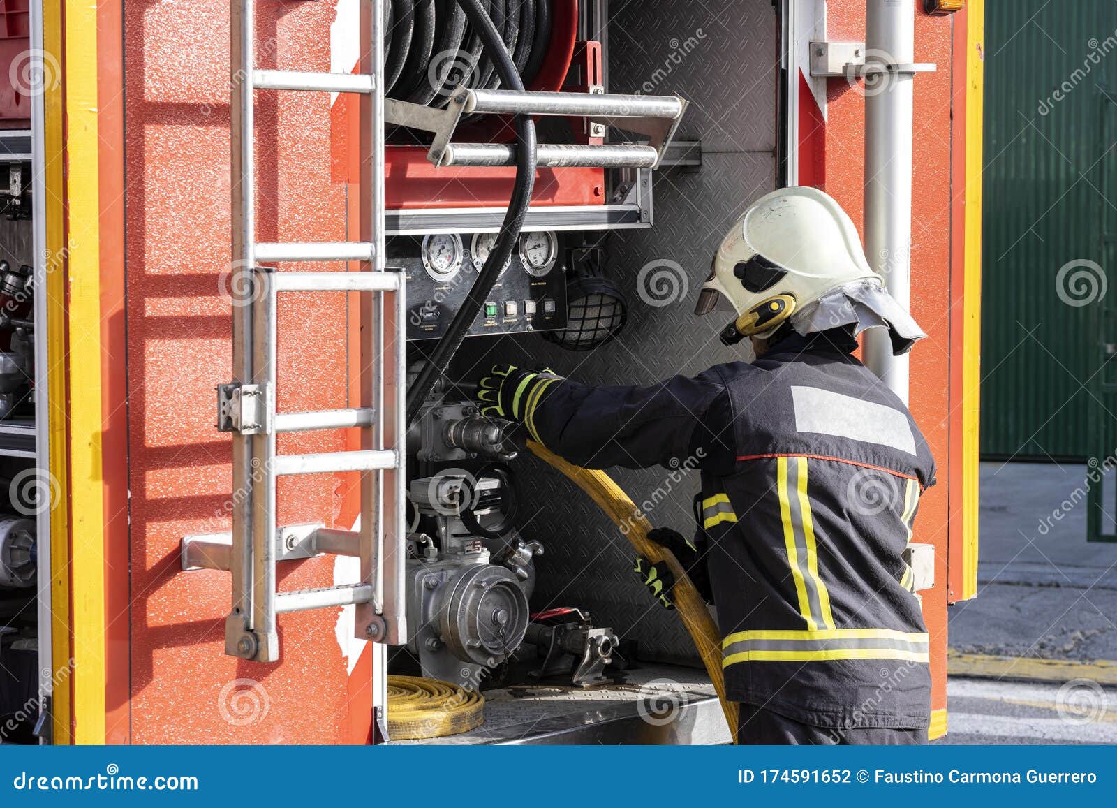 Equipped Firefighter Handling a Water Extraction Pump, Inside a Fire ...