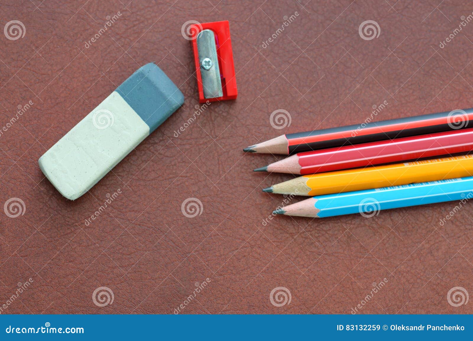 Eraser, Writing Pencils and a Sharpener on a Brown Leather Background ...