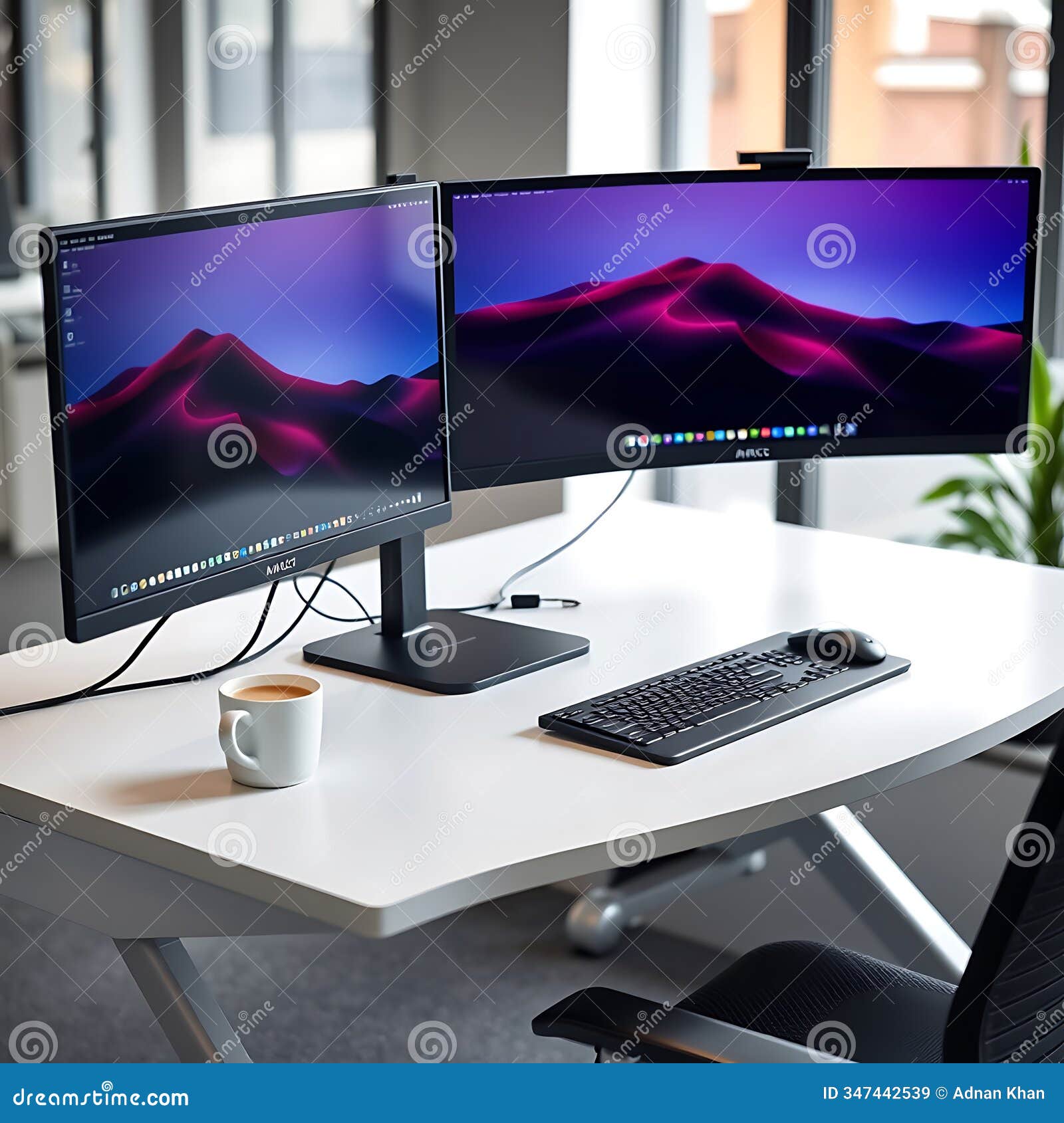 An Ergonomic Adjustable Desk with Multiple Monitors Keyboard and a Cup ...