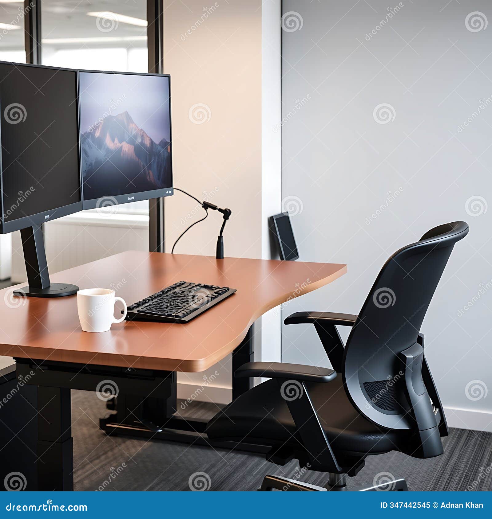 An Ergonomic Adjustable Desk with Multiple Monitors Keyboard and a Cup ...