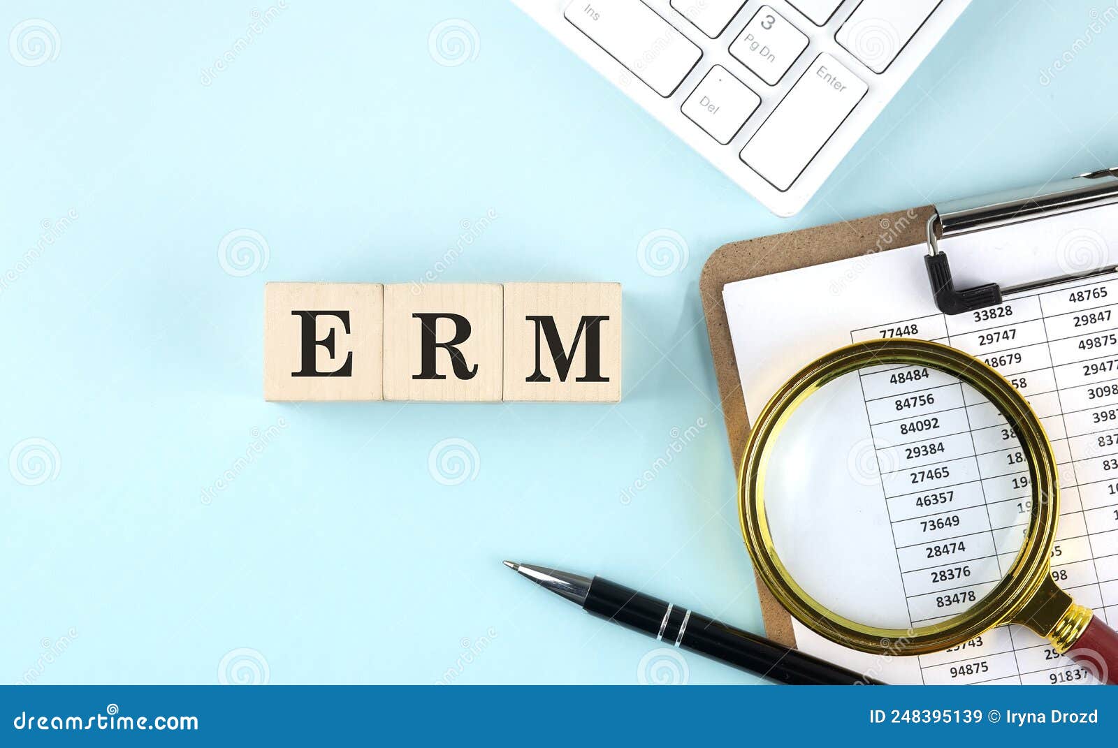 ERM Word on Wooden Cubes on Blue Background with Chart and Keyboard ...