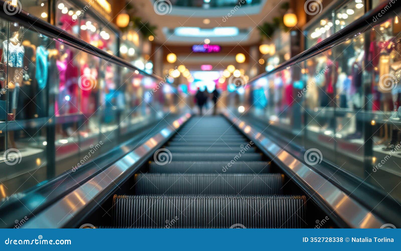 An Escalator in a Shopping Mall with Bright Shop Windows and People ...