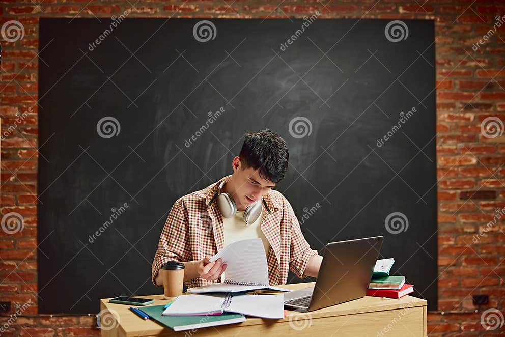 The Essence of Learning. Deeply Focused Young Man, Studying in ...